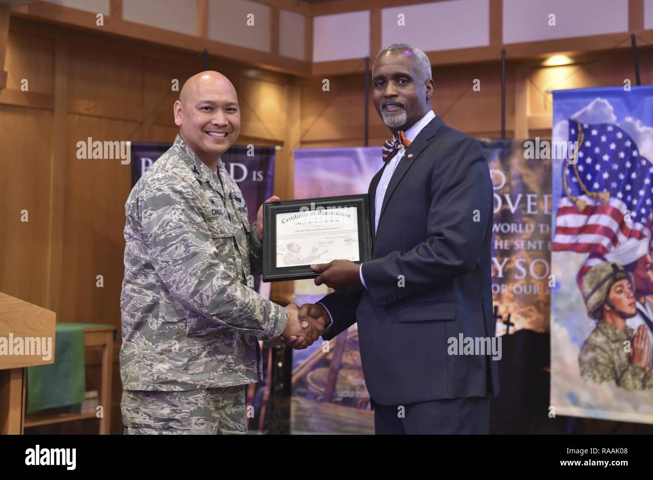 U.S. Air Force Col. Jimmy Canlas, 437 Airlift Wing commander, presents ...