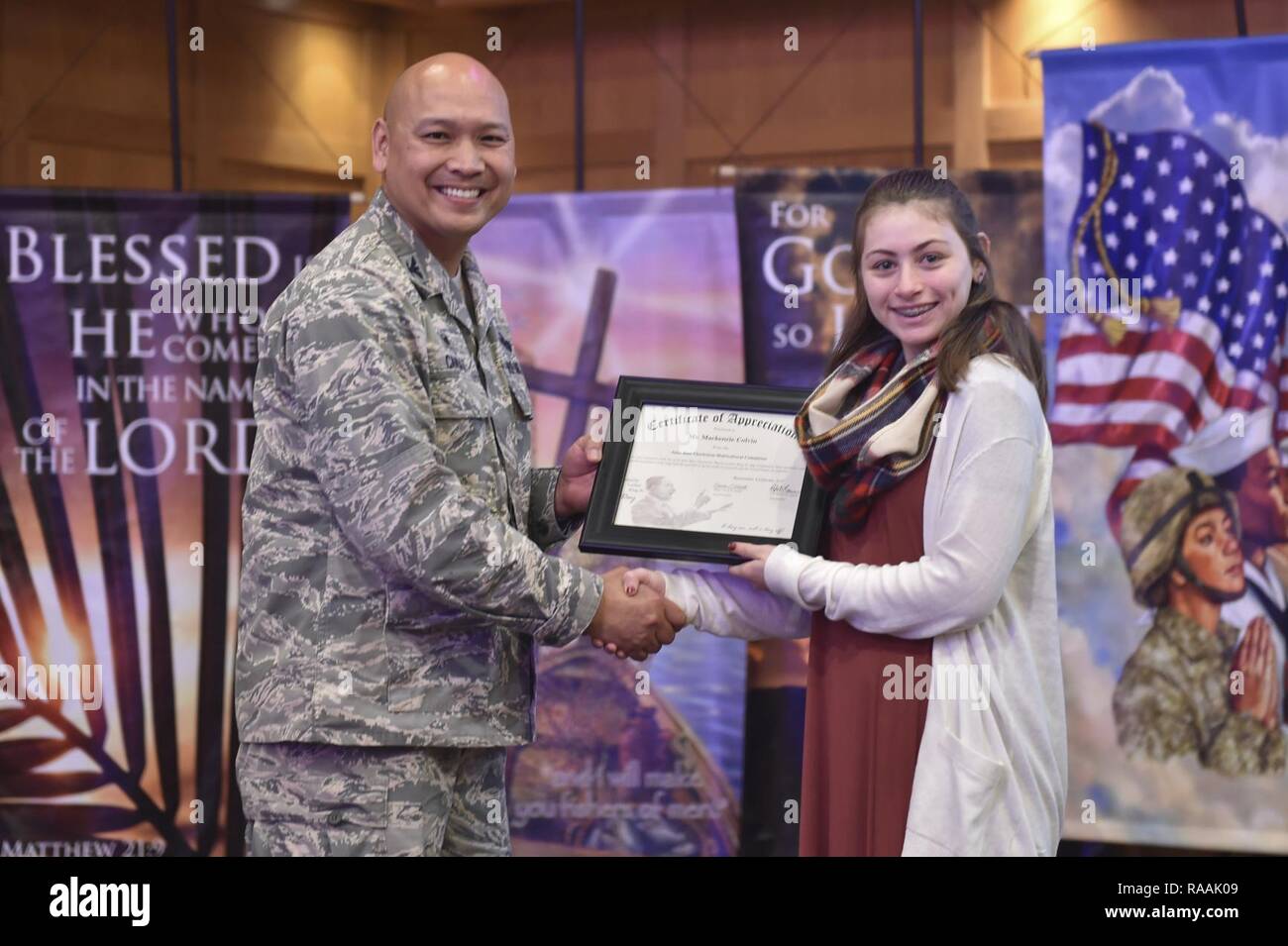 U.S. Air Force Col. Jimmy Canlas, 437 Airlift Wing commander, presents ...