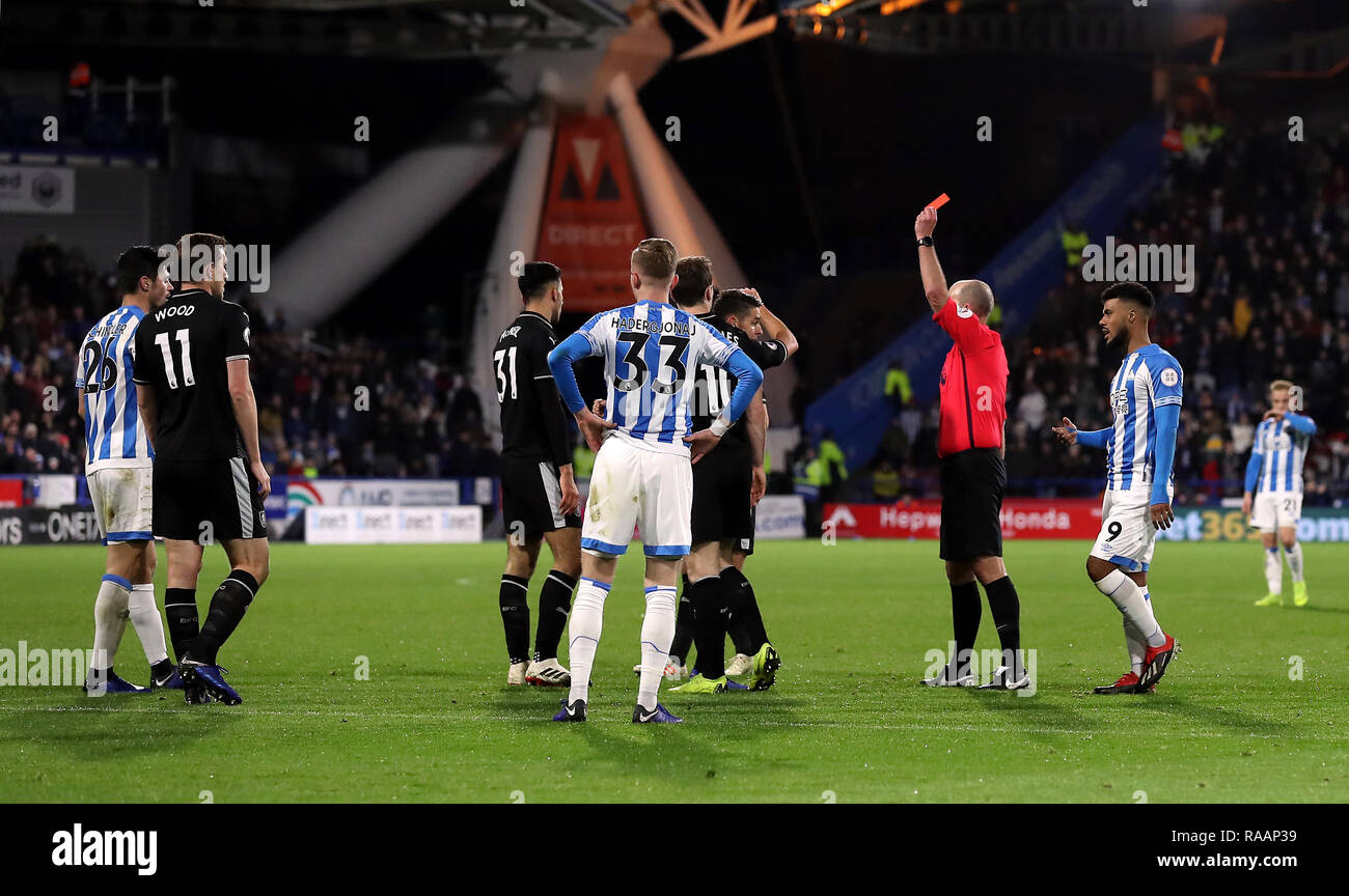 Huddersfield Town's Christopher Schindler (left) is shown a red card by ...
