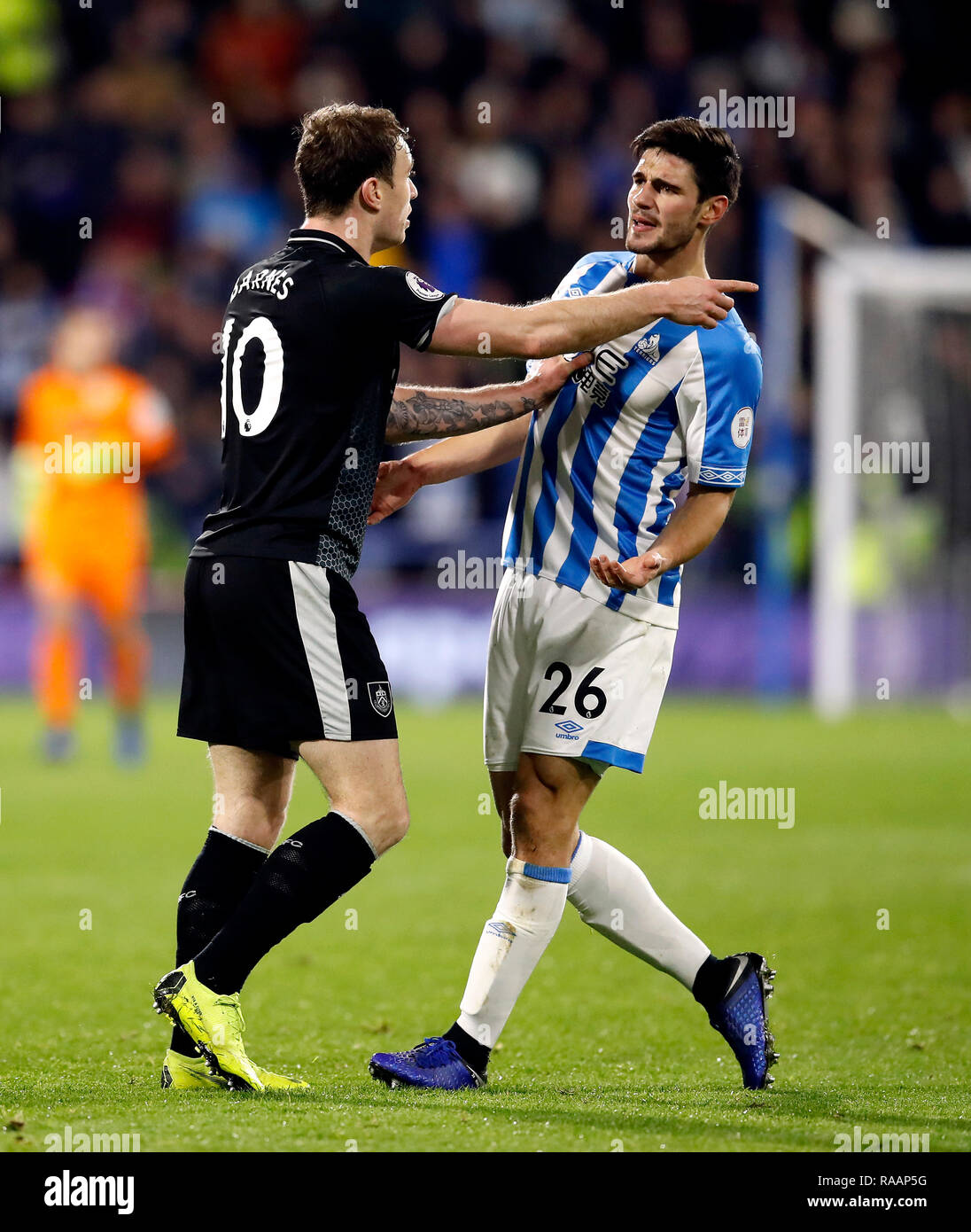 Huddersfield Town's Christopher Schindler is held back by Burnley's ...
