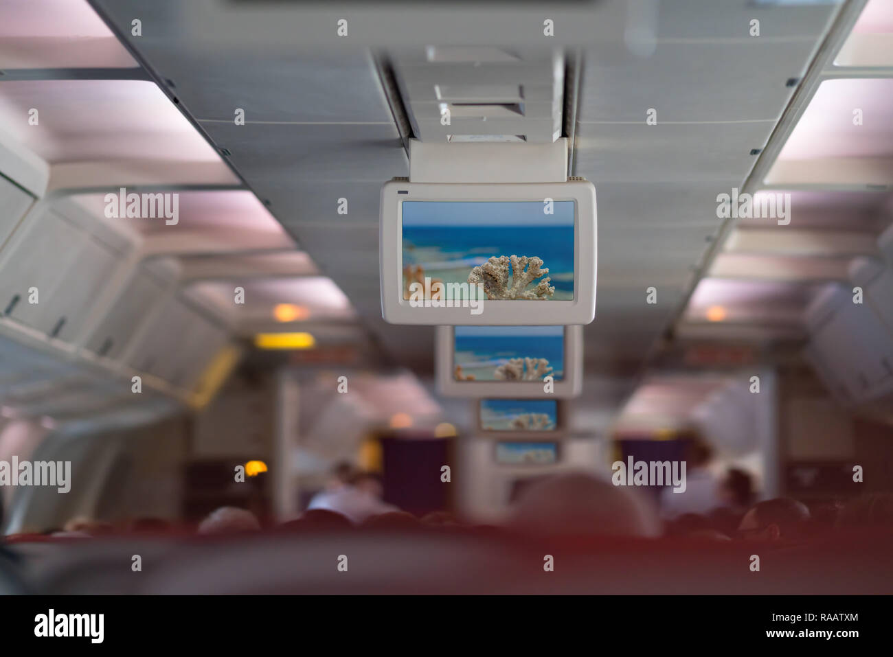 Inside an airplane cabin during a flight looking up at the film being ...