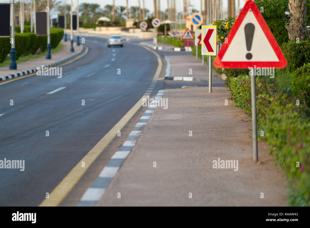 Warning sign on an urban street with an exclamation mark in a triangle ...