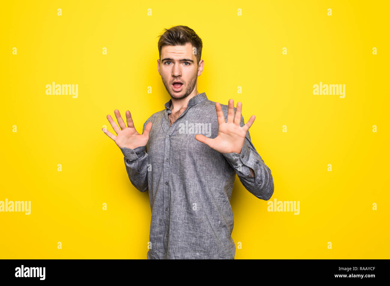 Man on isolated vibrant yellow color is a little bit nervous and scared ...