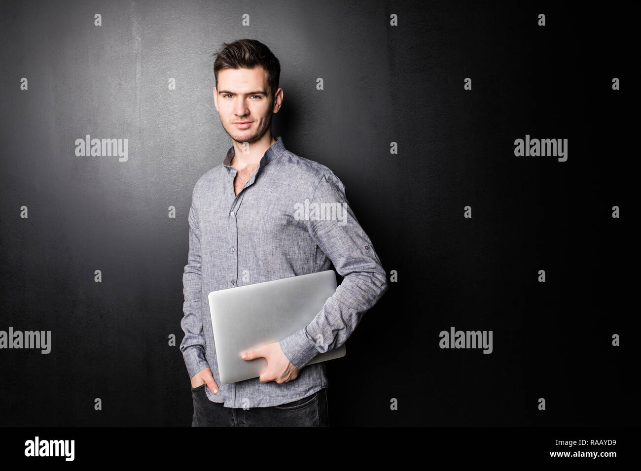 Smiling man using his laptop on white background Stock Photo - Alamy