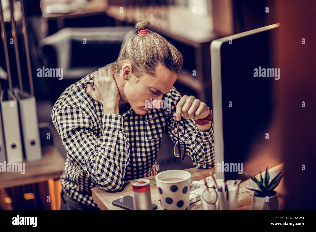 Upset male person having problem with health Stock Photo - Alamy