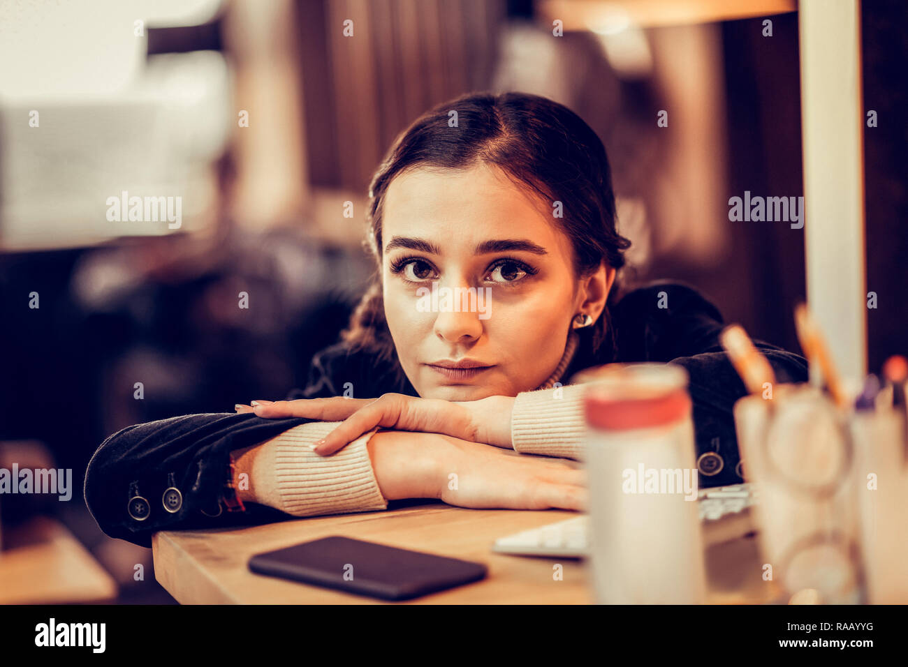 Attractive brunette woman looking straight at camera Stock Photo - Alamy