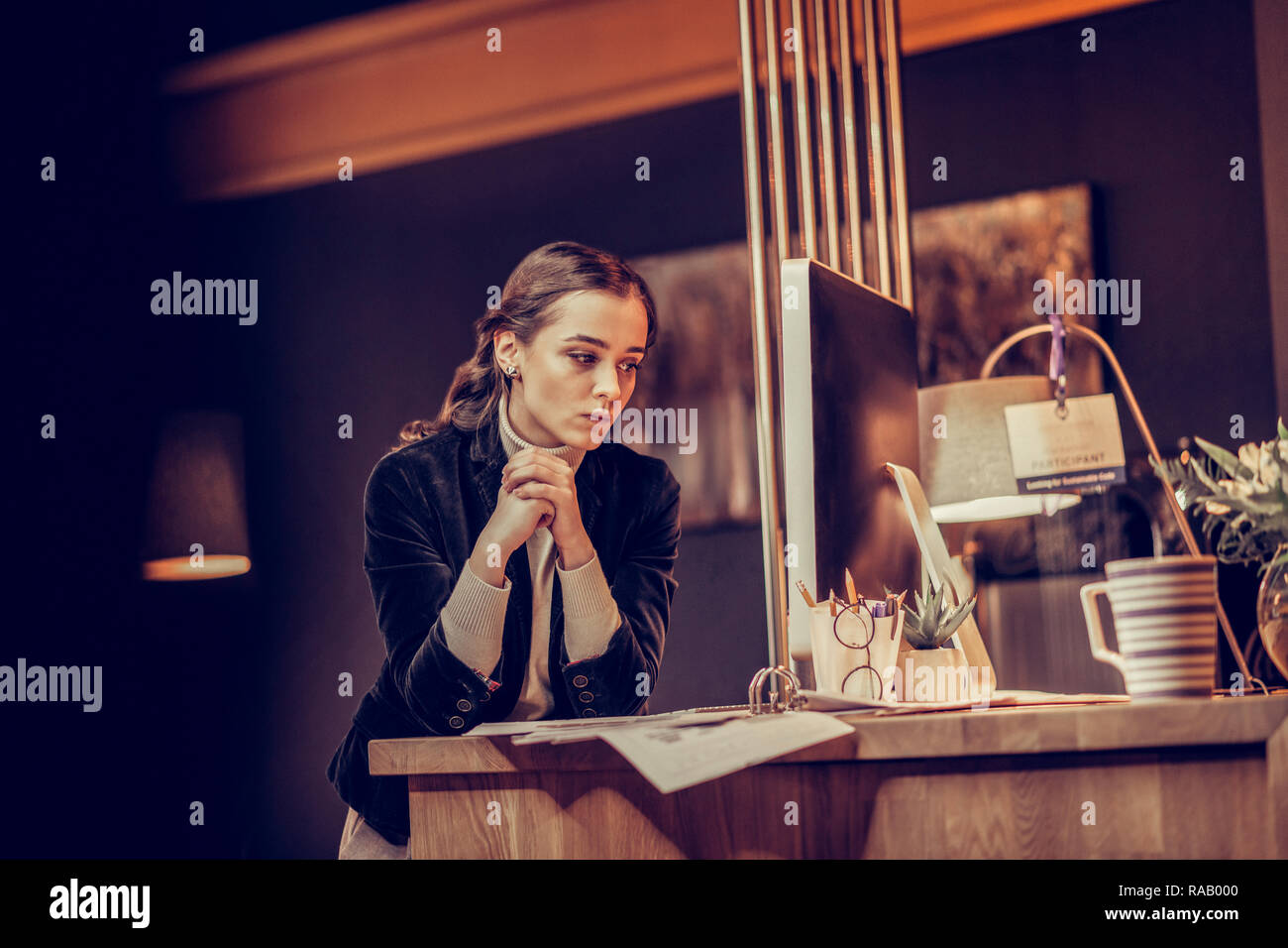 Beautiful brunette girl looking at her computer Stock Photo - Alamy