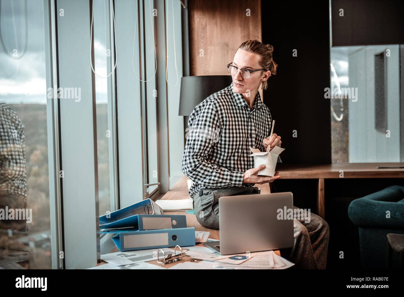 Frustrated male looking at window while having pause Stock Photo - Alamy