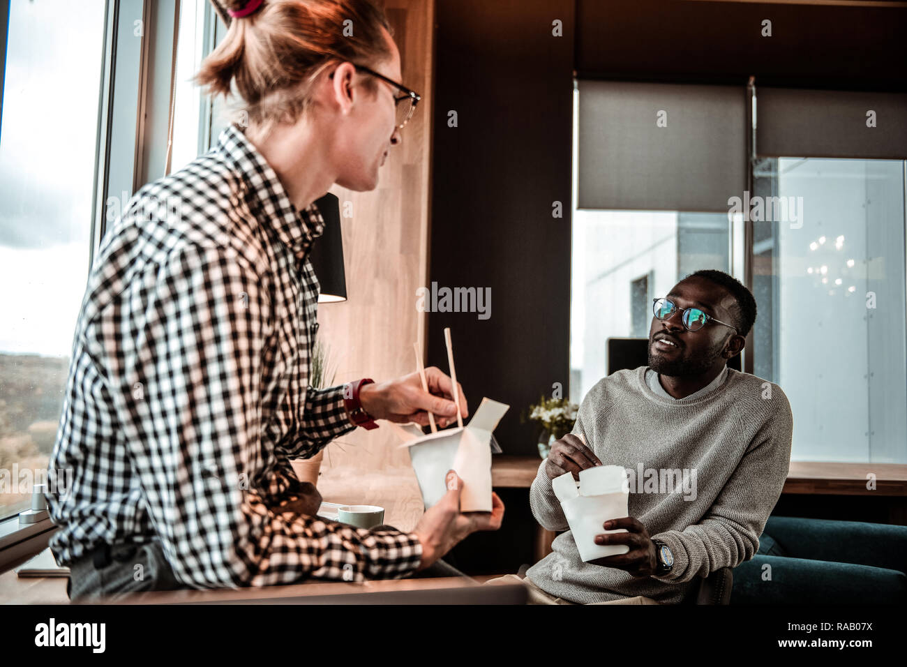 Positive delighted males talking during their pause Stock Photo - Alamy