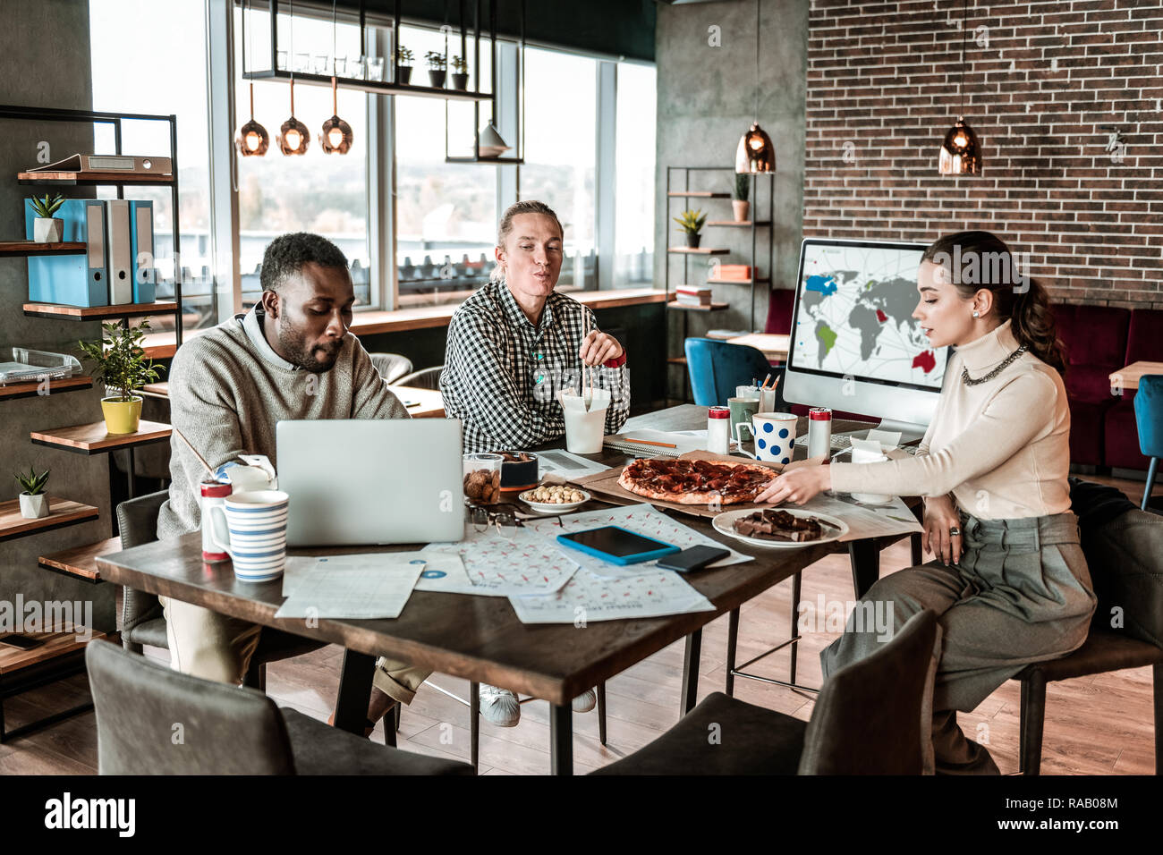 Group of young colleagues having dinner together Stock Photo - Alamy