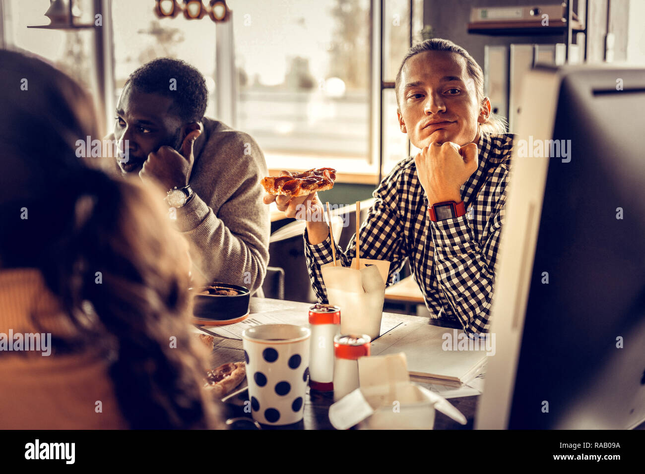Cheerful blonde male staring at screen of computer Stock Photo - Alamy
