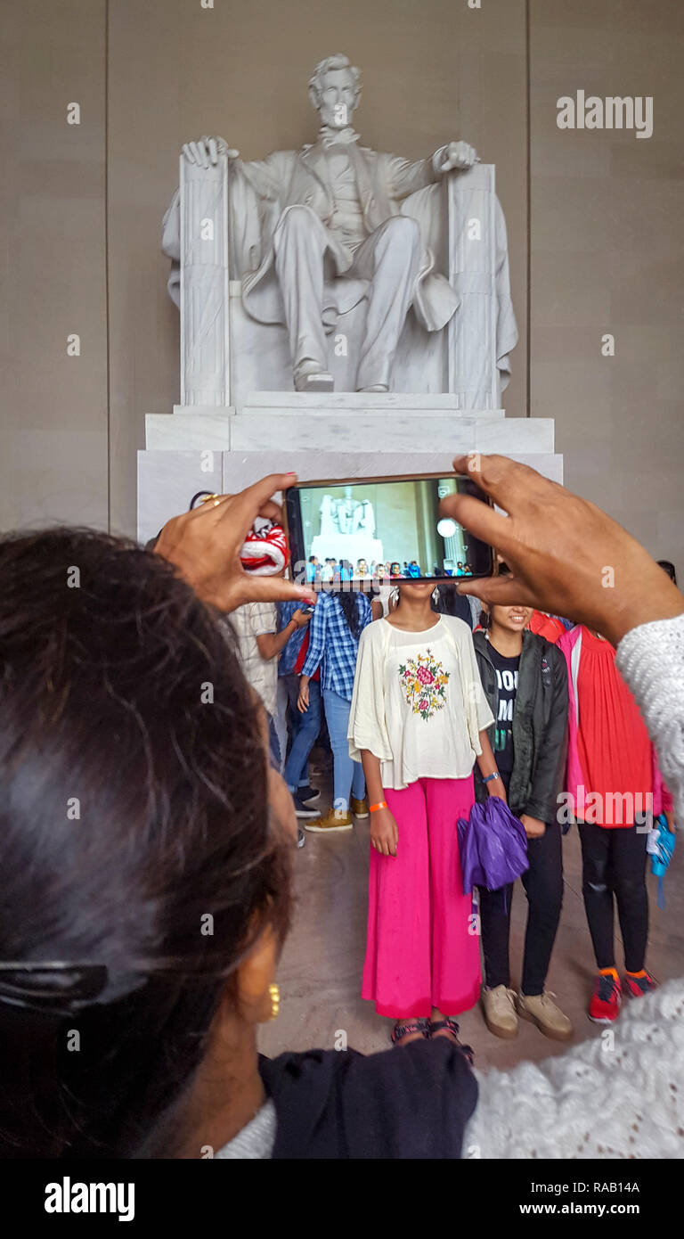 People having their photograph taken in front of the Abraham Lincoln ...