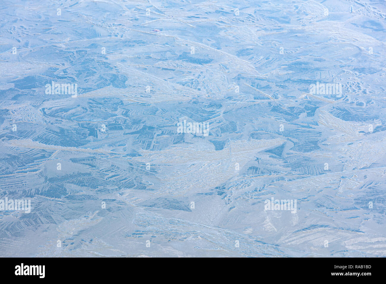 texture of ice surface with cracks and snow pattern. winter icy river ...