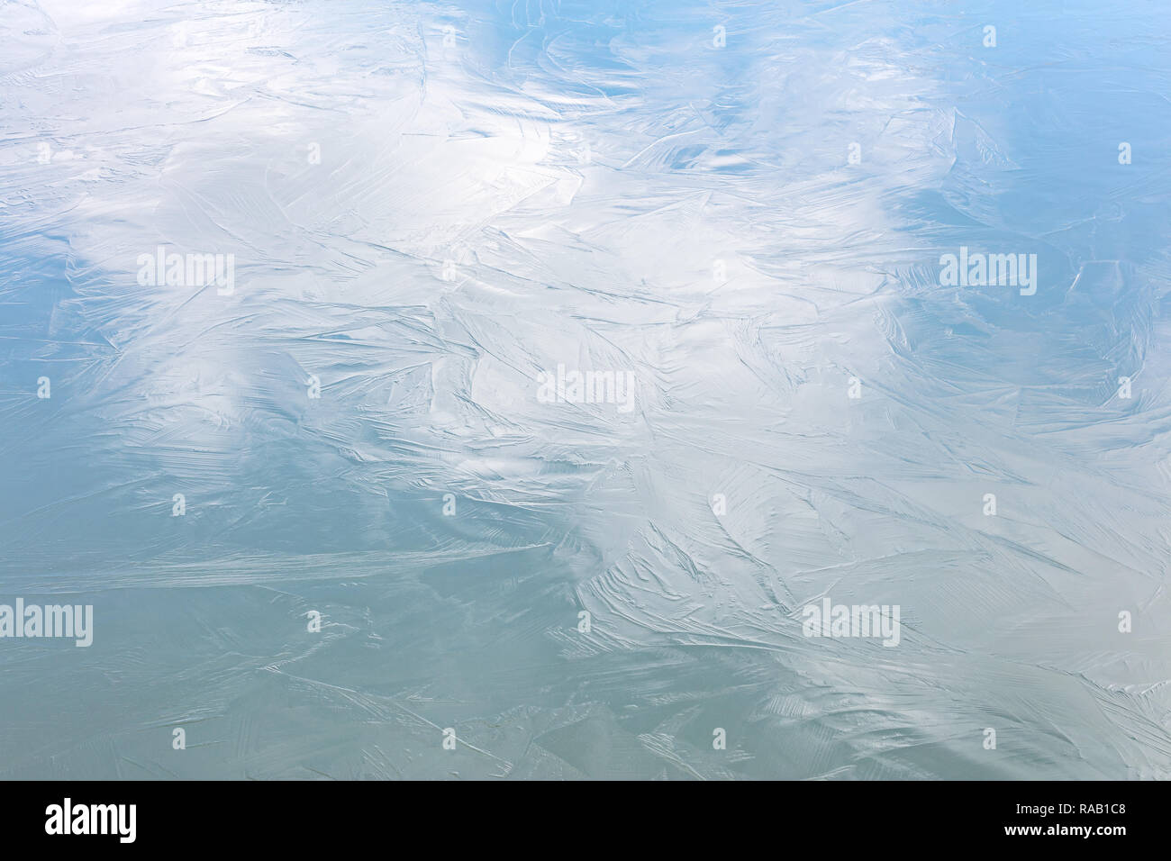 sky reflecting on ice surface. winter pattern textured frost background ...