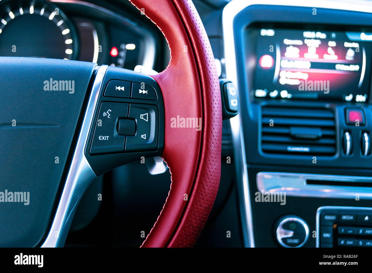 Media control buttons on the red steering wheel in black leather with ...