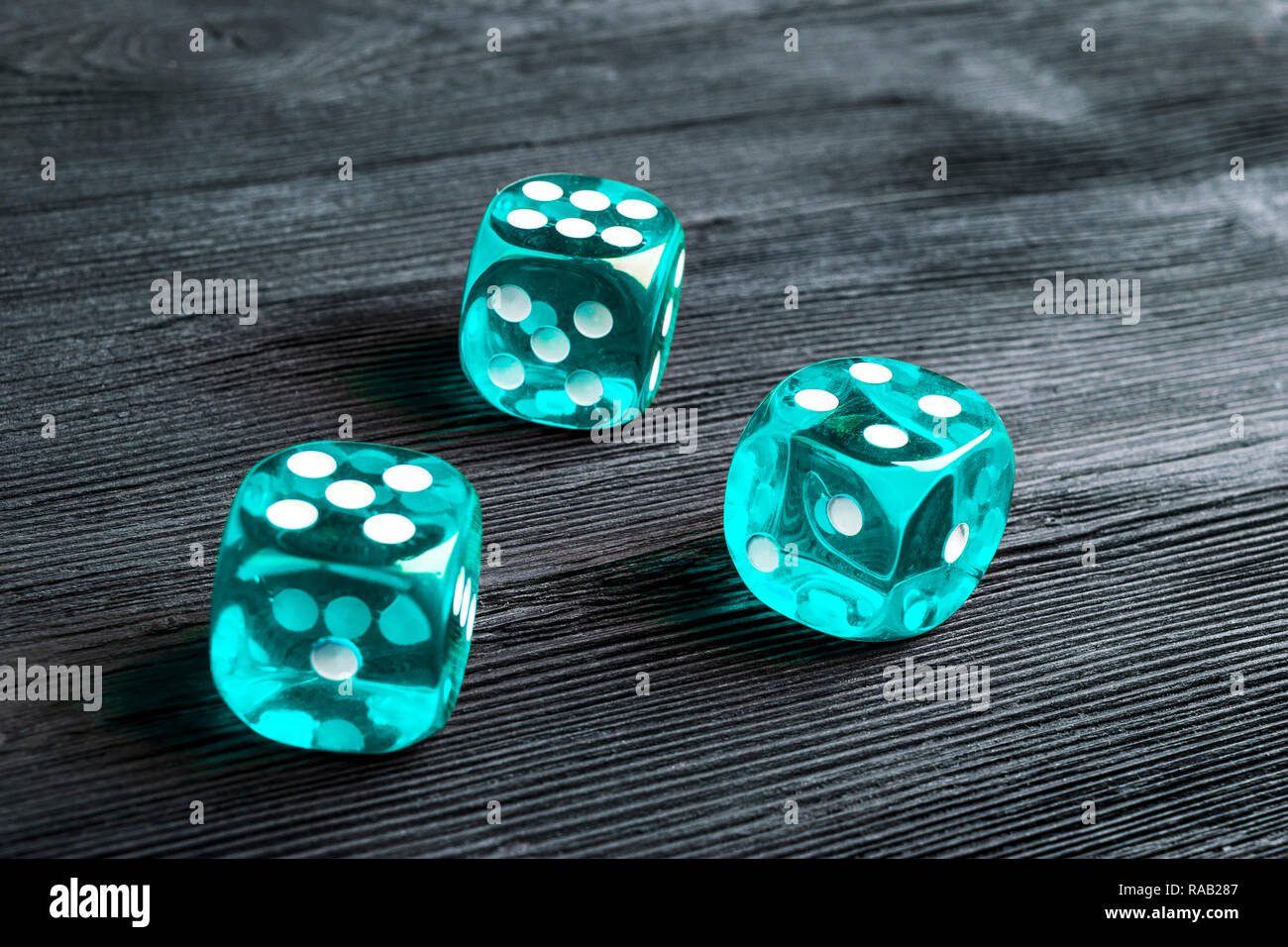risk concept - playing dice at black wooden background. Playing a game ...