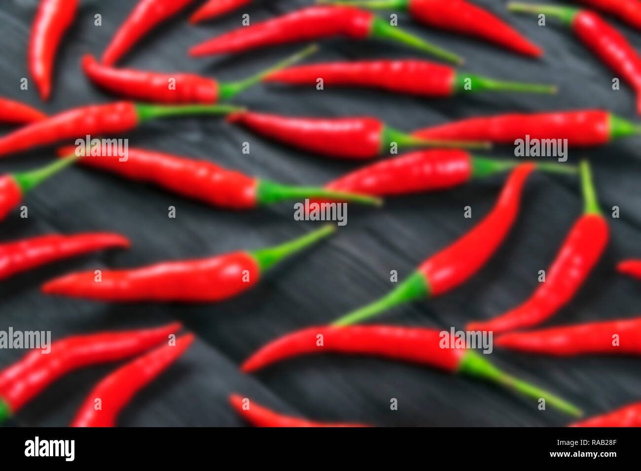 Blurred background with Red chili pepper on the blur dark wood kitchen ...