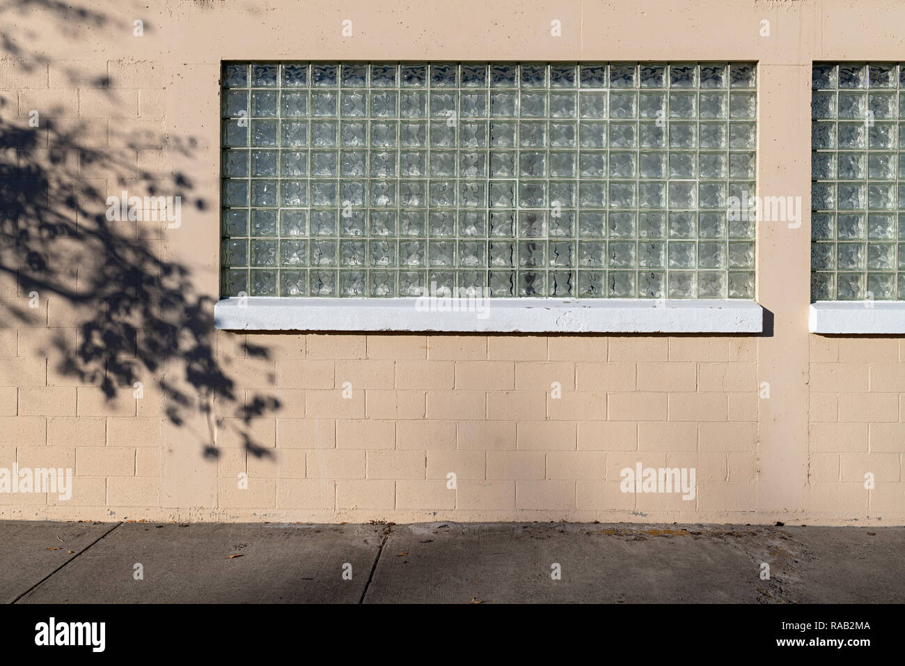 Glass block windows and concrete block wall Stock Photo - Alamy