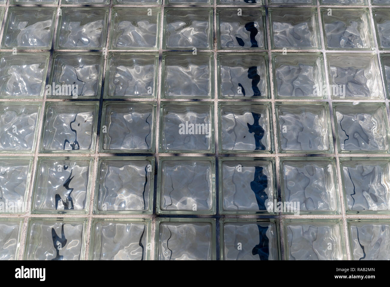 Patterns in a glass block window Stock Photo - Alamy