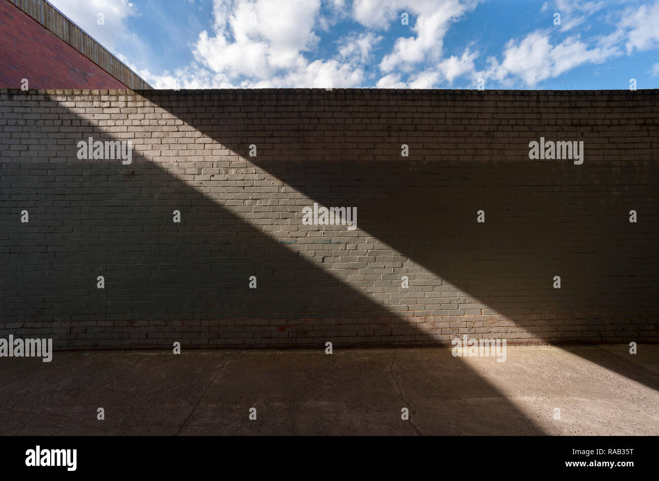 Sunlight strip on brick wall Stock Photo - Alamy