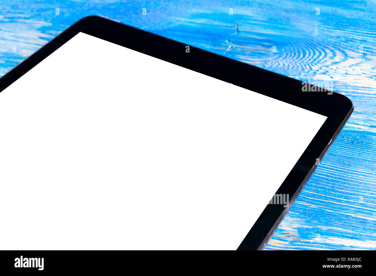 Tablet computer PC with blank screen mock up on black wooden table ...