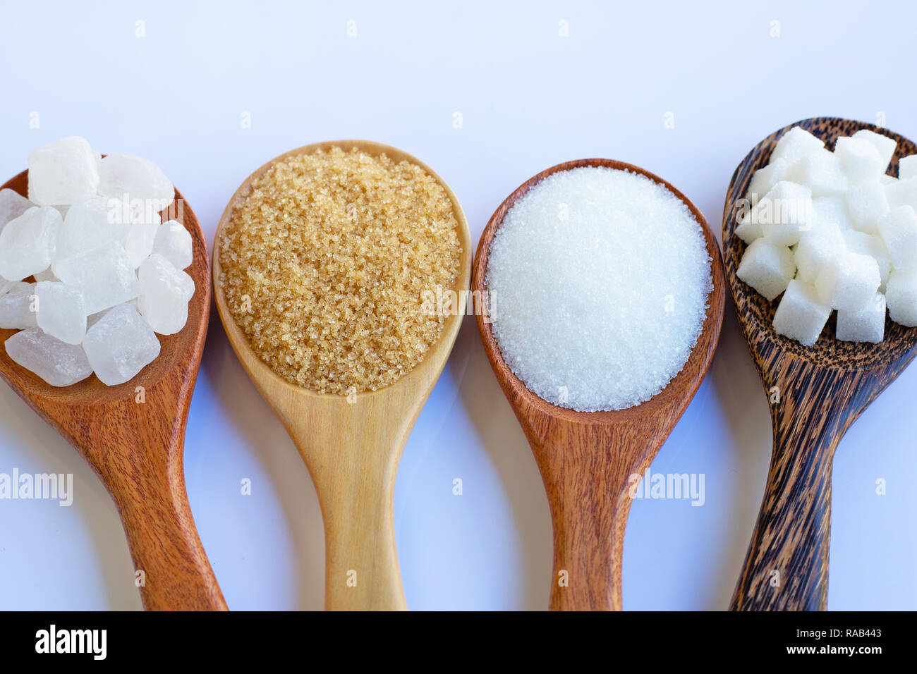 Various types of sugar on white background Stock Photo - Alamy