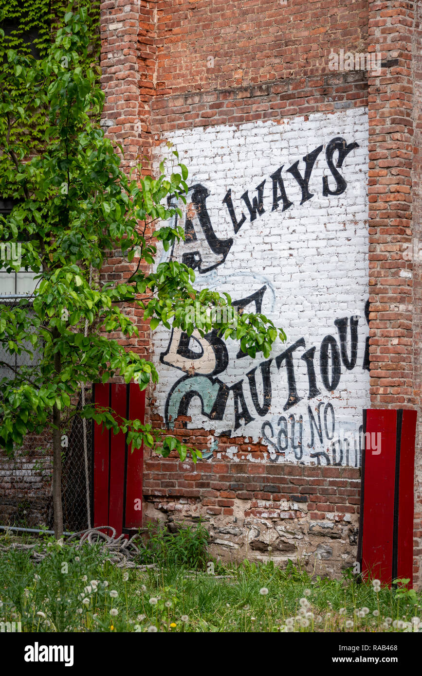 Always Be Cautious, a hand painted sign in a park yard in Harlem, New ...