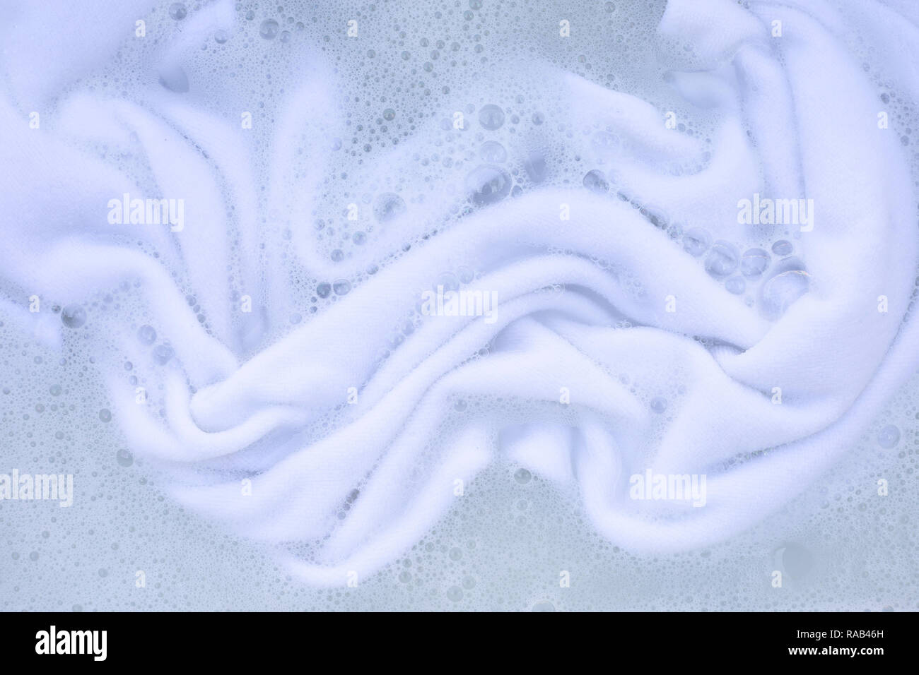 Soak a cloth before washing, white cloth Stock Photo - Alamy