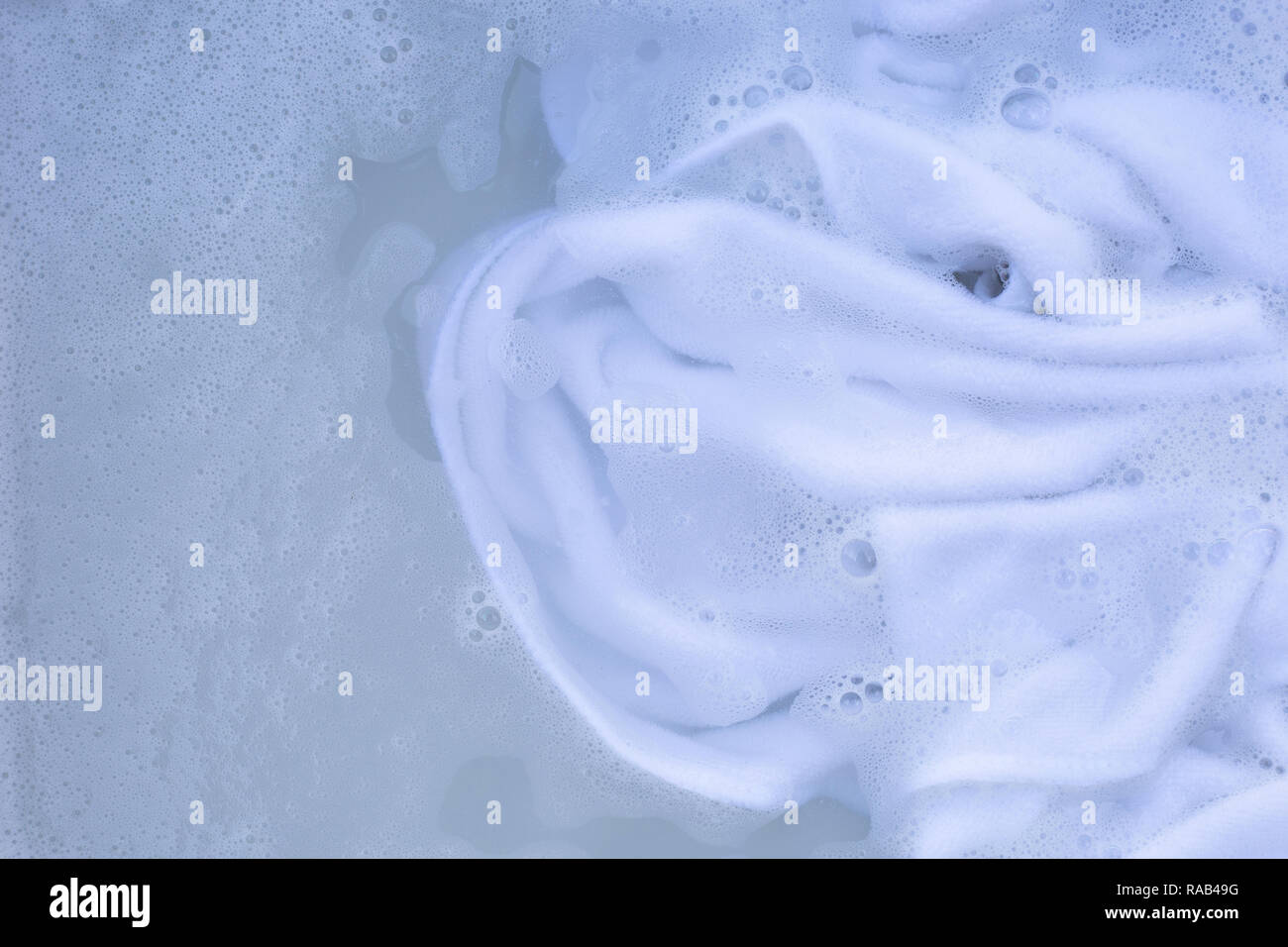 Soak a cloth before washing, white cloth Stock Photo - Alamy