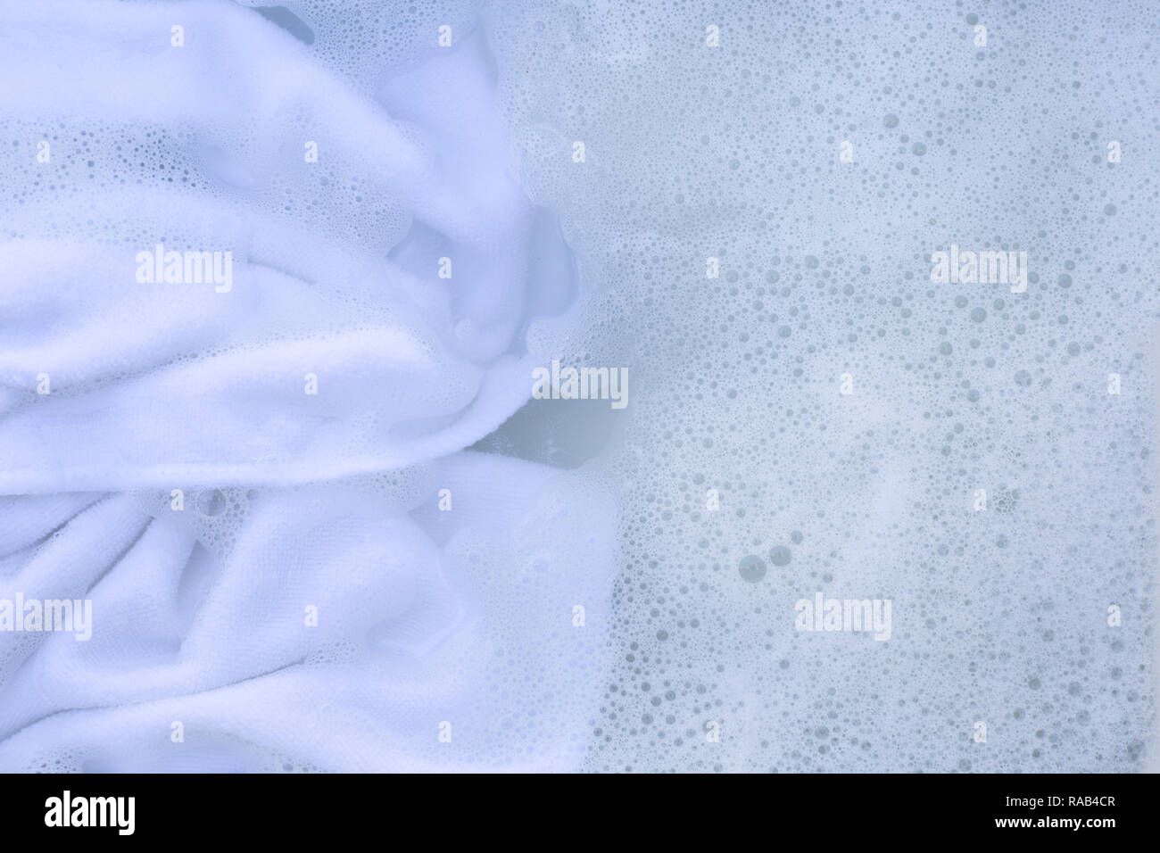 Soak a cloth before washing, white cloth Stock Photo - Alamy