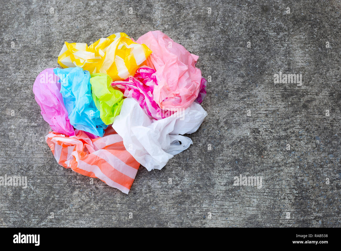 Plastic bags waste on cement floor background Stock Photo - Alamy
