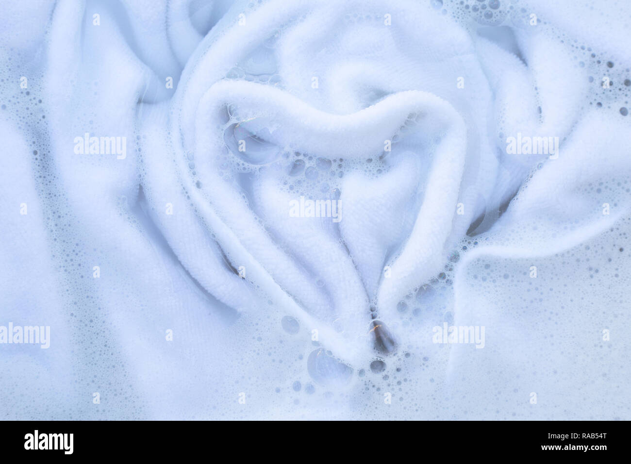 Soak a cloth before washing, white cloth Stock Photo - Alamy