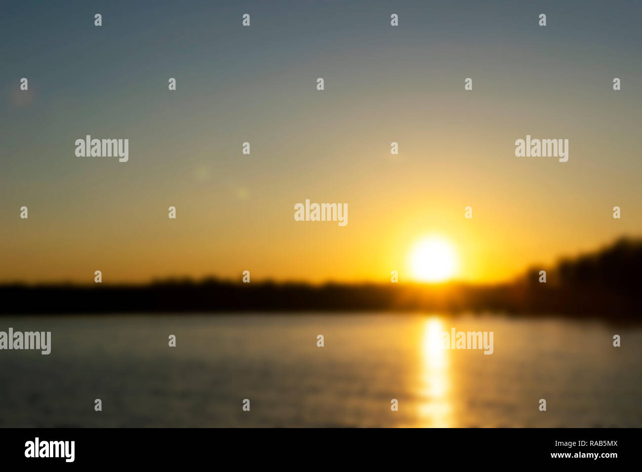 Blurred background of Summer lake landscape with golden sunrise. River ...