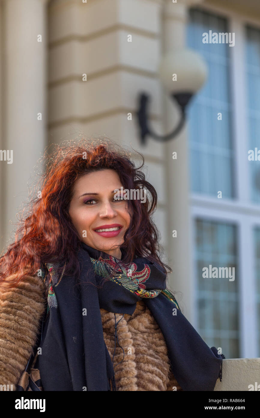 classy woman smiling with Arabic somatic features walking in Italian ...