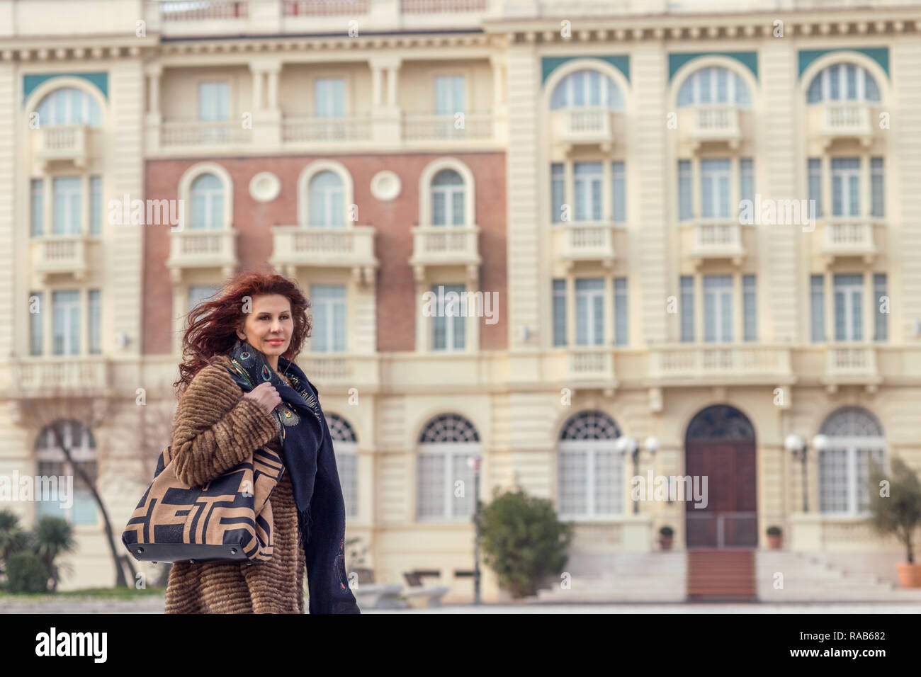 classy woman smiling with Arabic somatic features walking in Italian ...