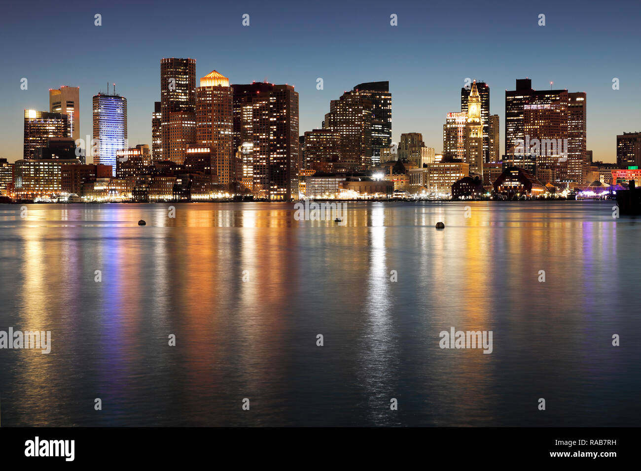 Boston Harbor skyline at dusk, city lights, from Piers Park, East ...