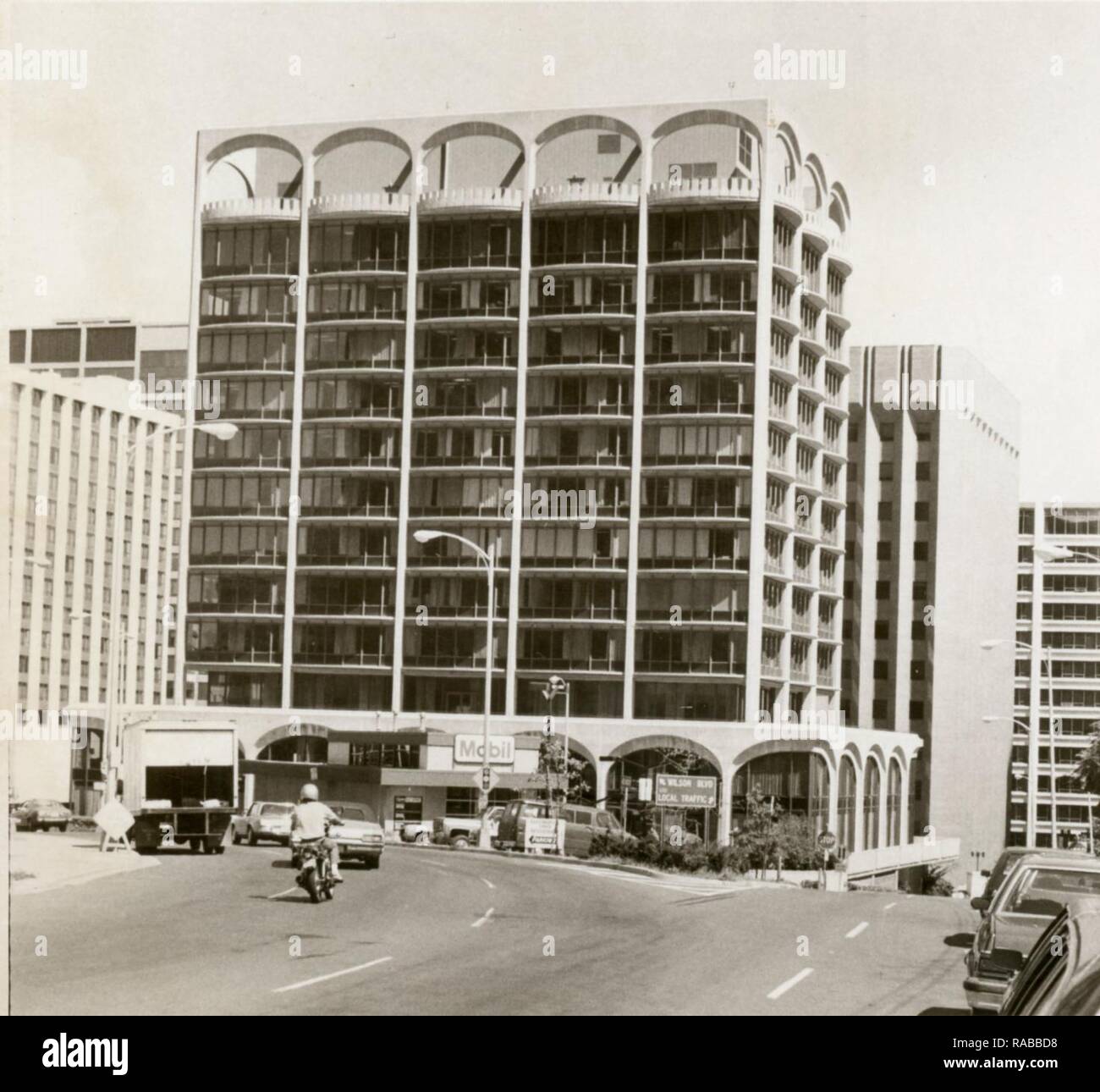 THIS PICTURE SHOWS A BUILDING AND THESE A MOBIL GAS STATION IN FRONT OF ...