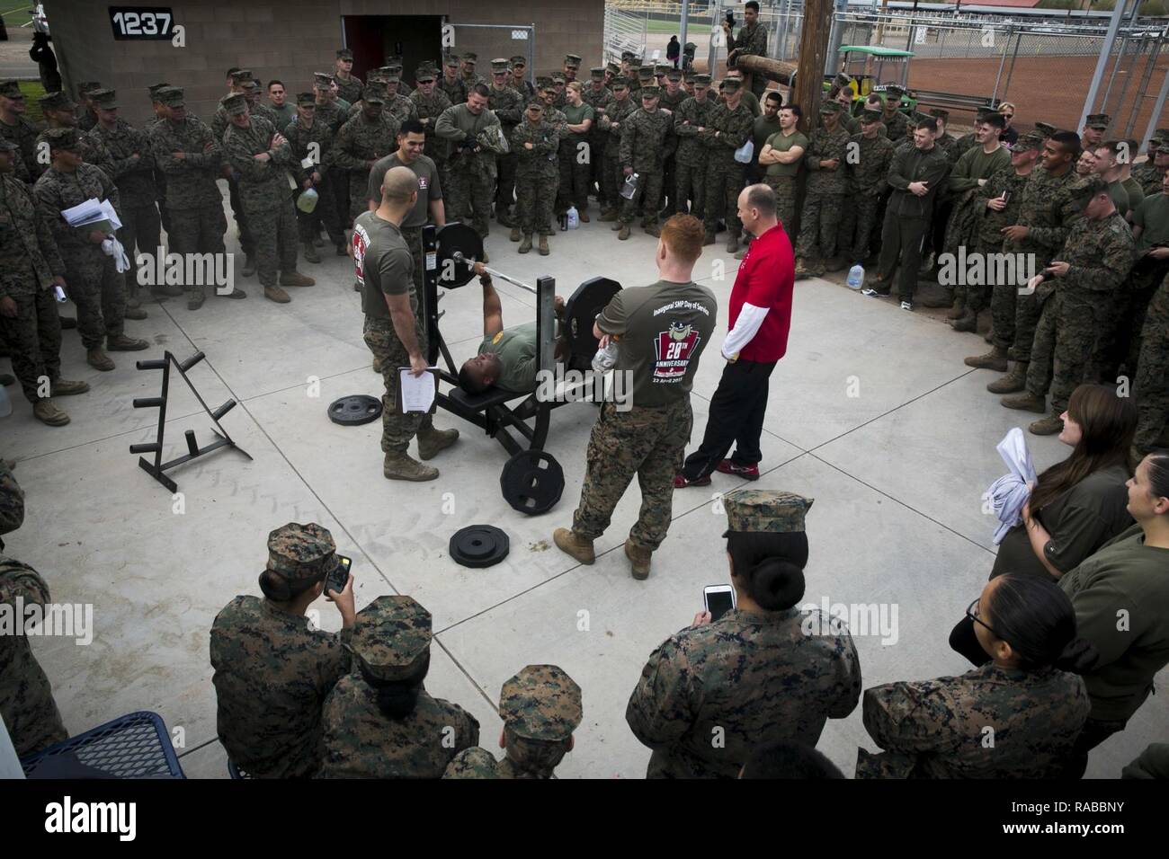 Marines from various squadrons gather around the bench press challenge ...