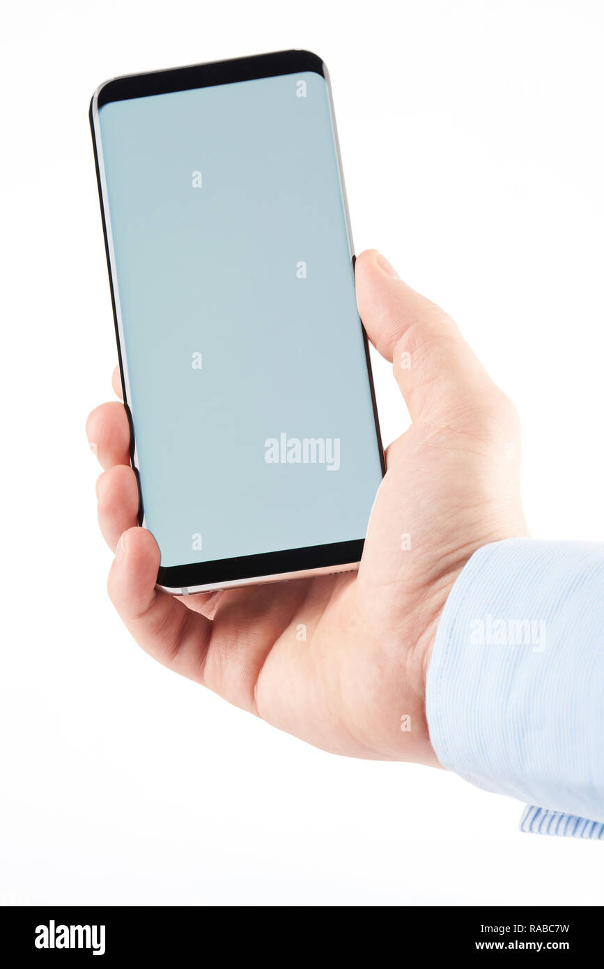 Holding modern smartphone with big screen close-up isolated on white ...