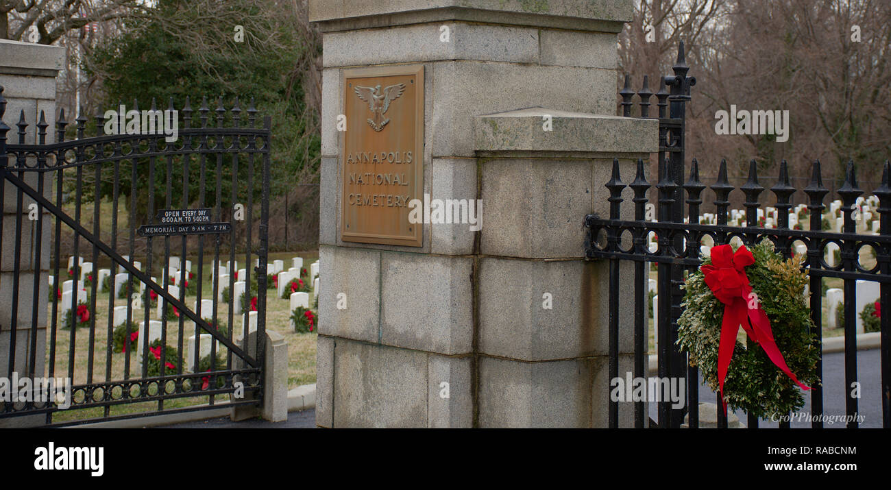 Entrance gate to Annapolis National Cemetery with grave stones in ...