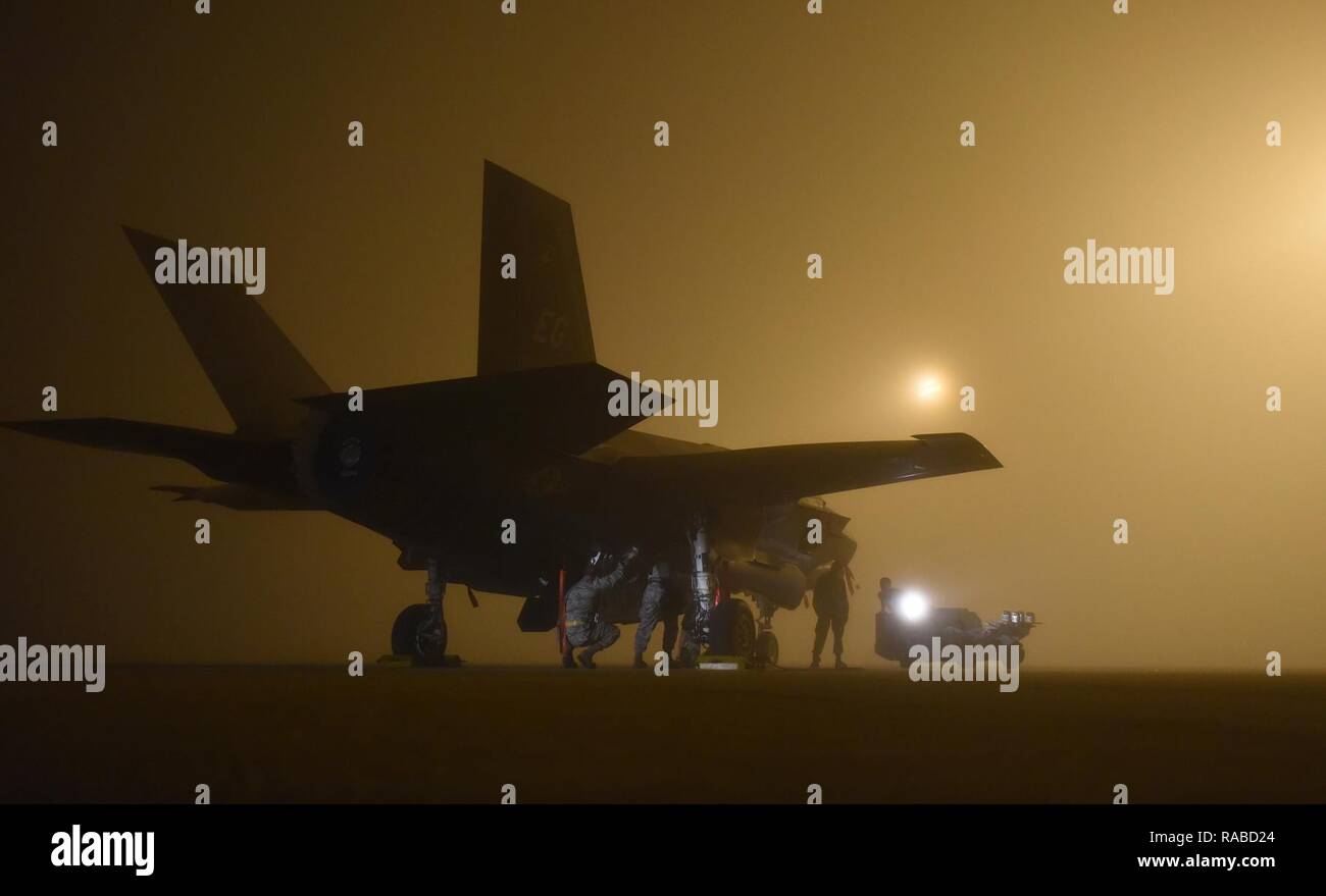 A U.S. Air Force weapons load crew assigned to the 33rd Aircraft Maintenance Squadron loads a ...