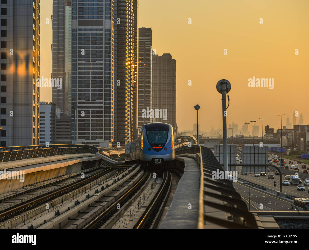 Dubai, UAE - Dec 10, 2018. A metro train running on track at sunset ...