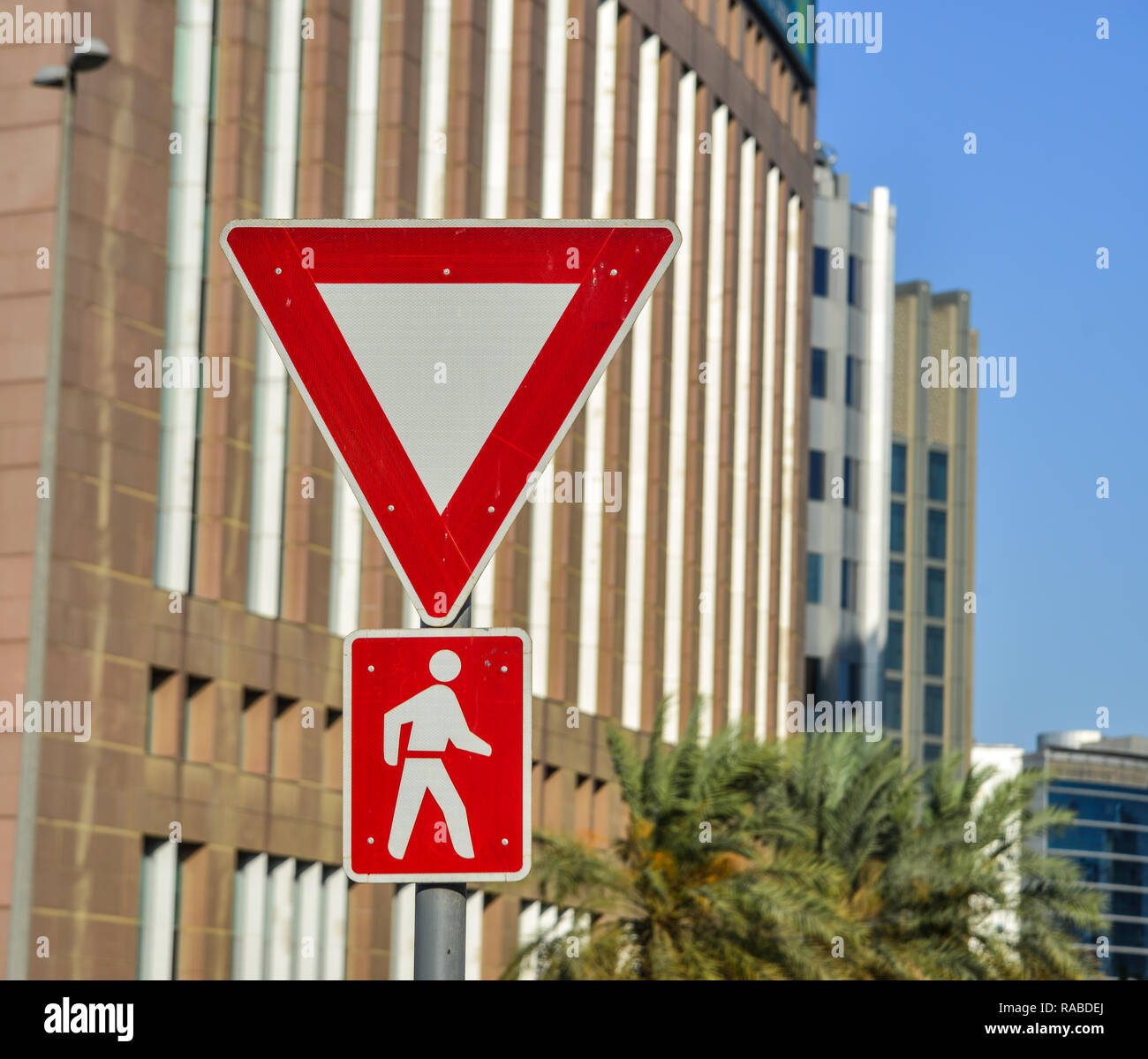 Caution pedestrian, road sign with modern building background in Dubai ...