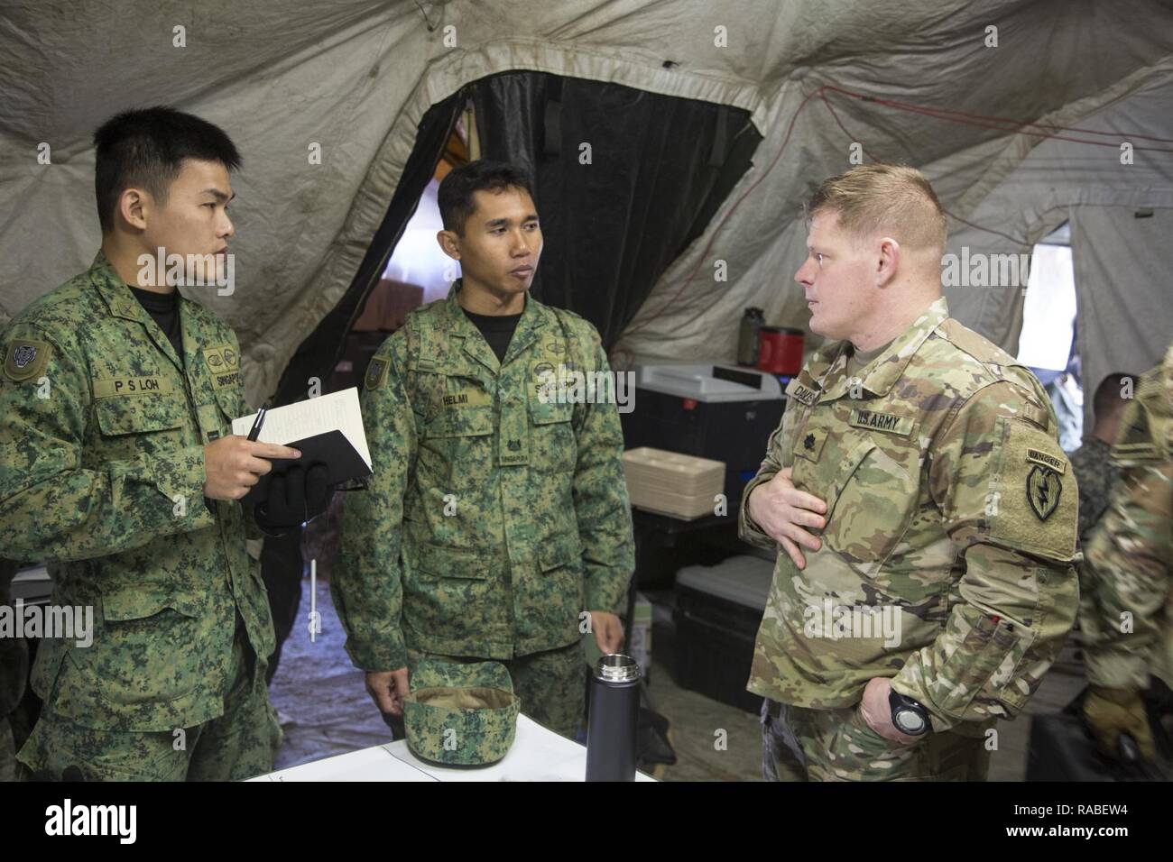 A U.S. Army officer attends a brief with members of the Singapore Army ...