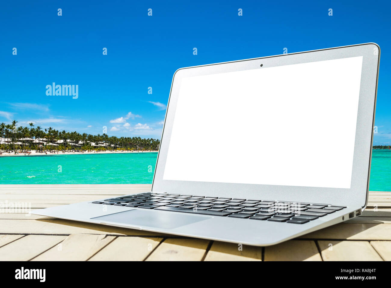 Laptop computer on wooden table. Top ocean view. Tropical island ...