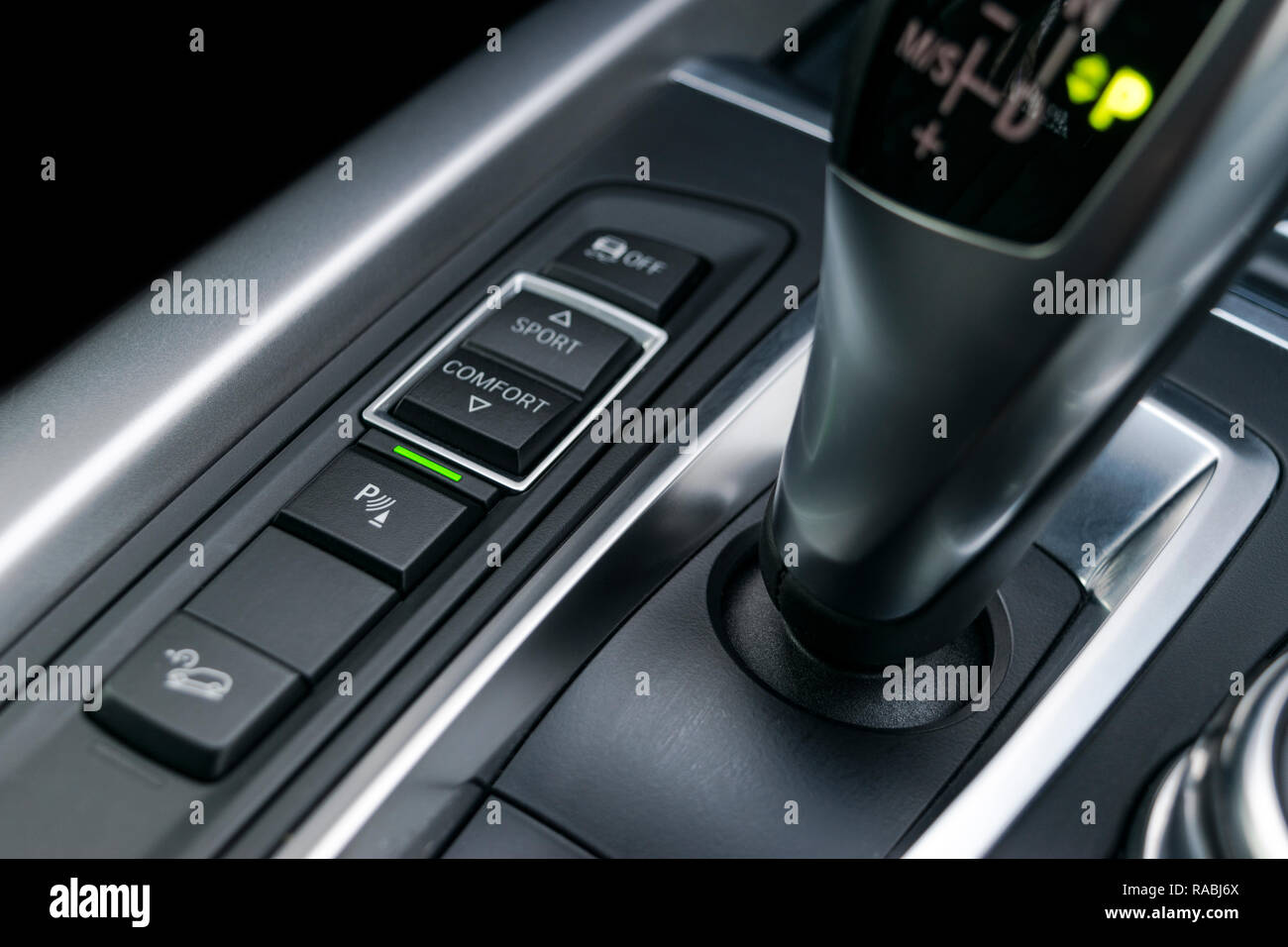 Track and parking sensor control buttons near automatic gear stick of a ...