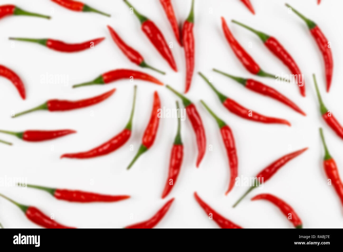 Blurred background with Fresh pods of red chilli peppers on white blur ...
