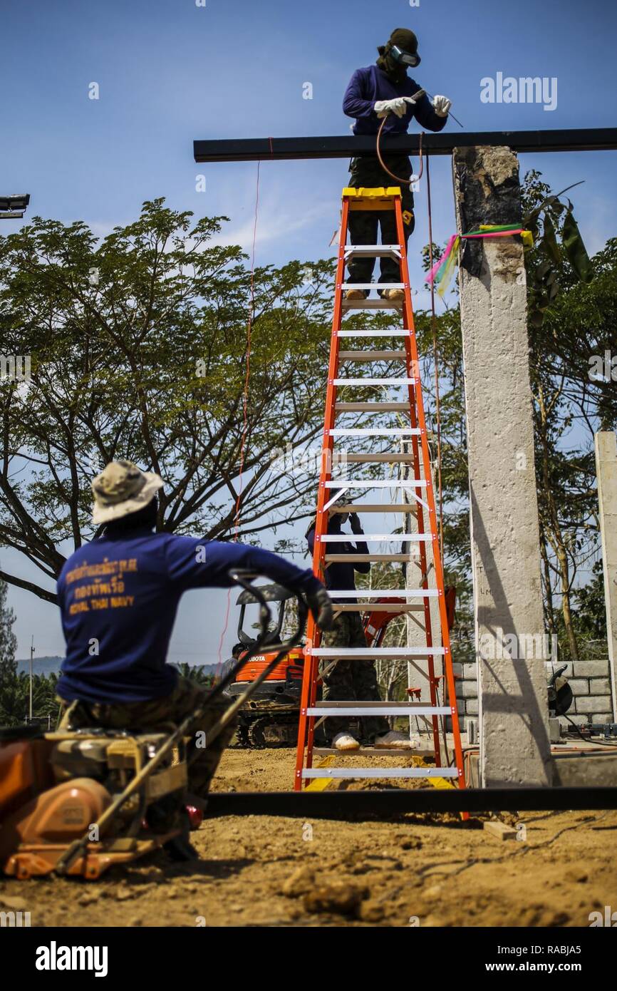 A Royal Thai Navy Sailor welds a beam during the construction of a ...