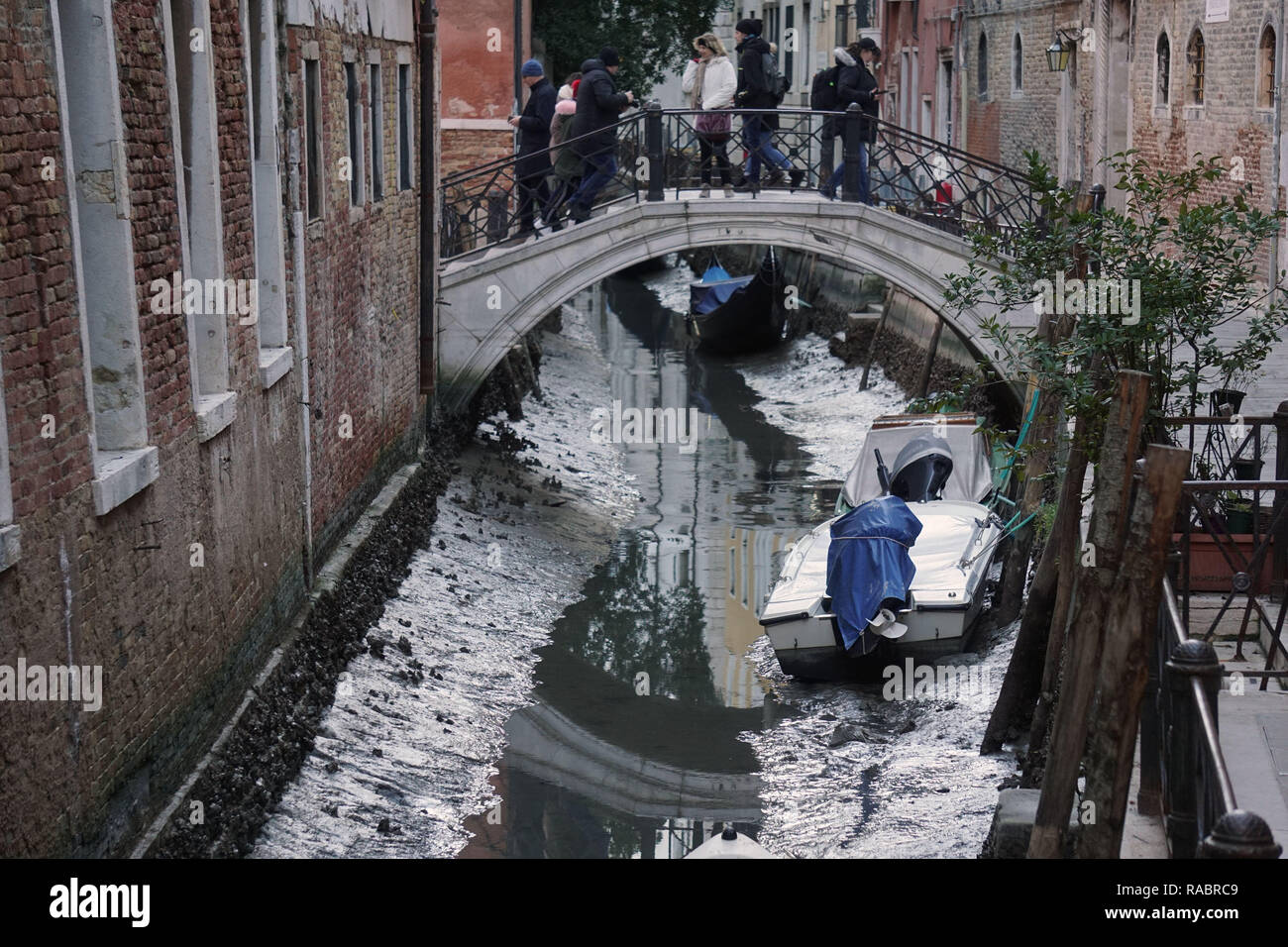 Venice, Italy. 03rd January, 2019. Boats are stucked along a canal ...