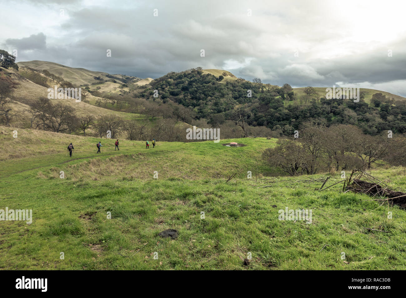 Hikers in Green Hills Country under Dramatic Clouds, Sunol Regional ...